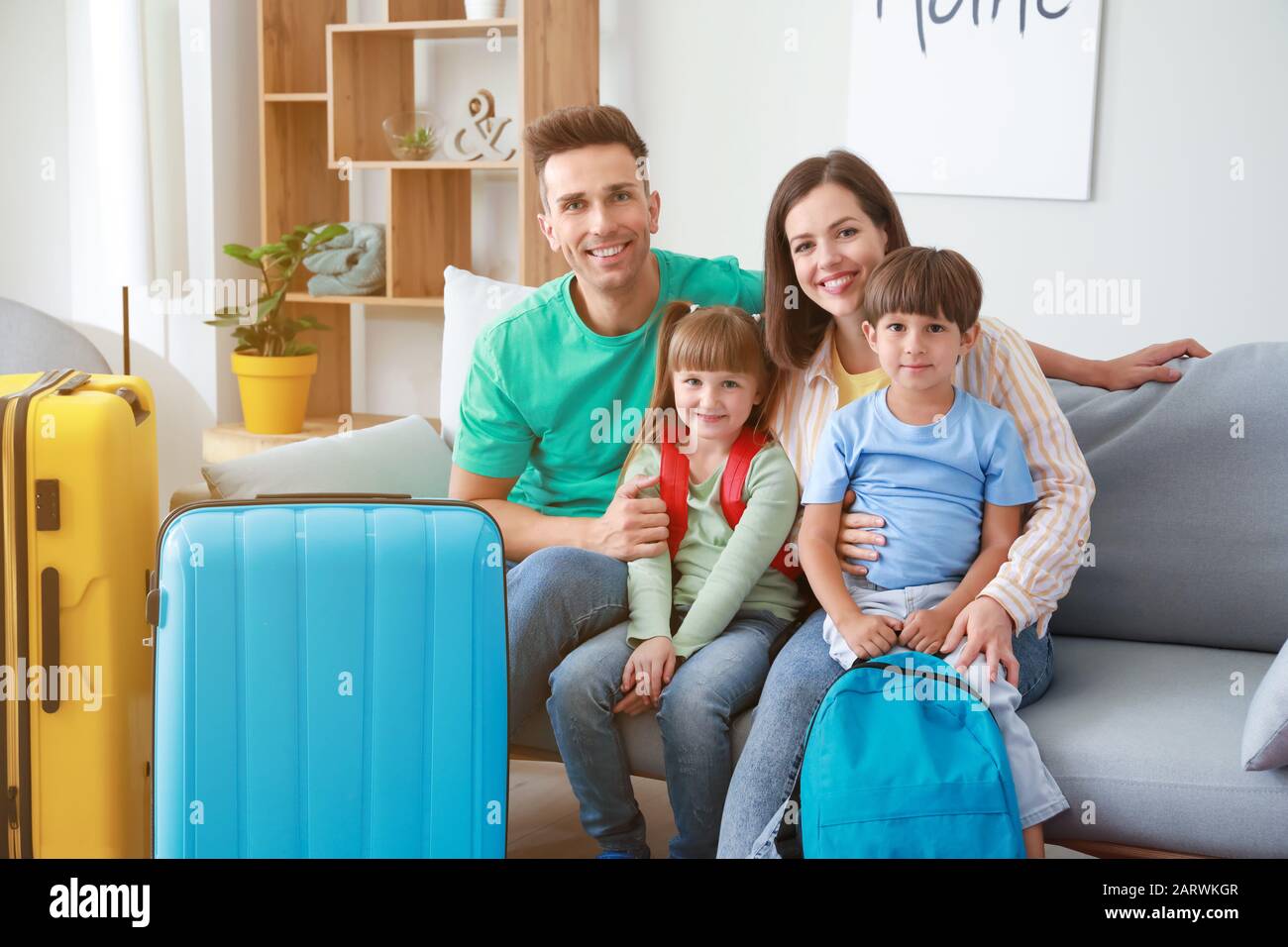 Happy family with packed suitcases at home Stock Photo - Alamy