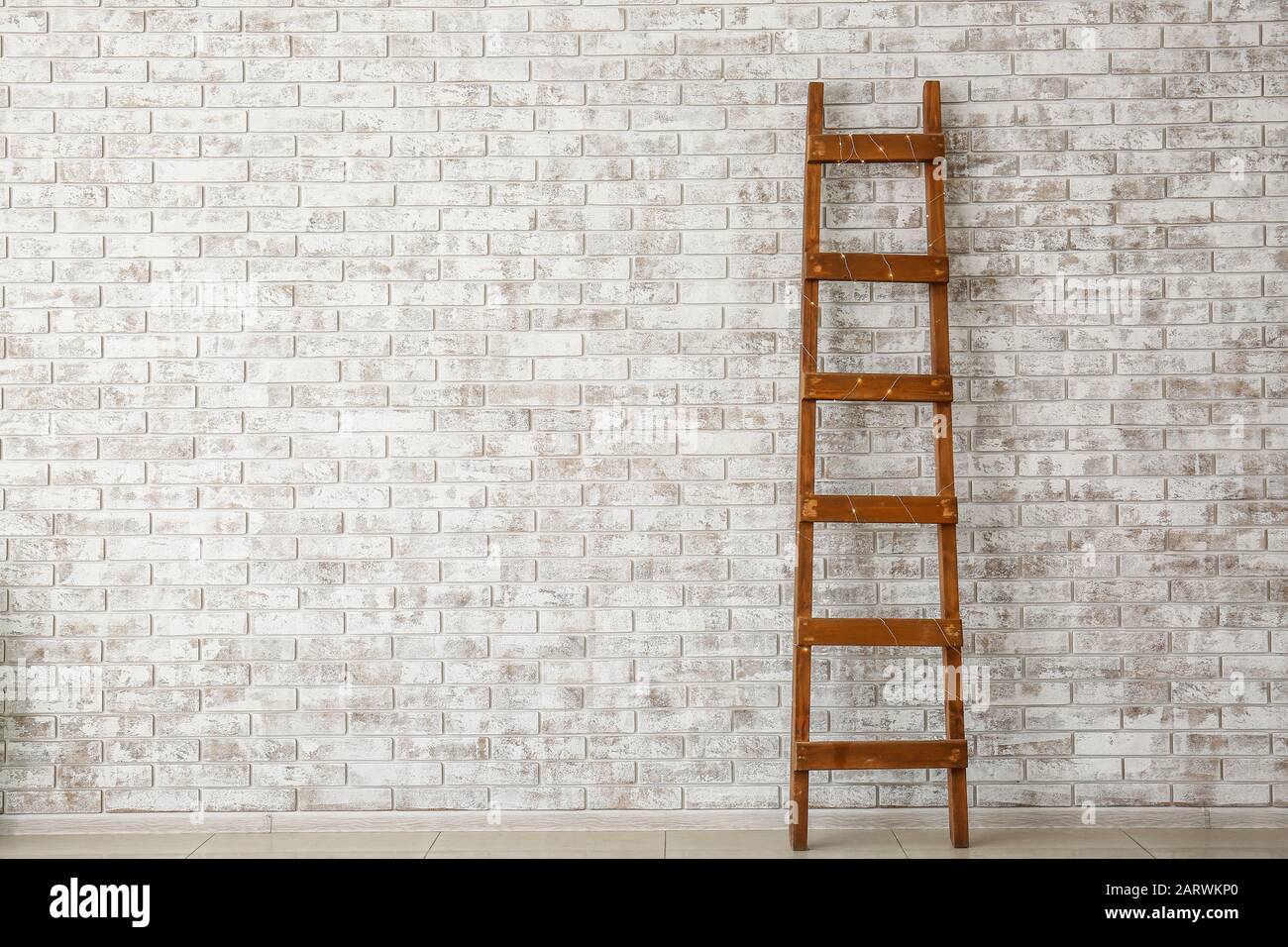 Wooden ladder near brick wall Stock Photo - Alamy