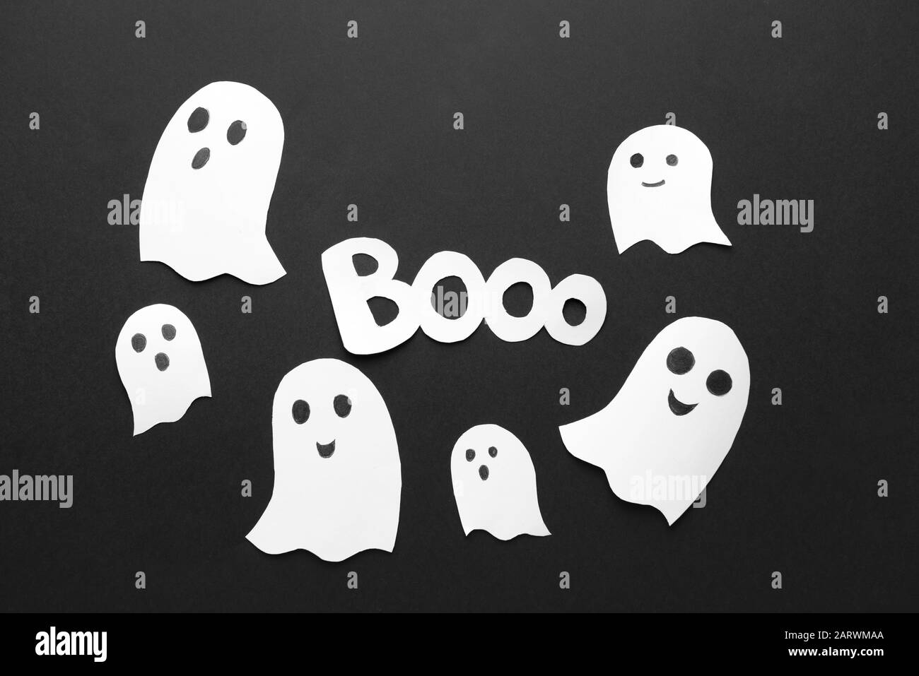 Paper ghosts as decor for Halloween party on black background Stock ...