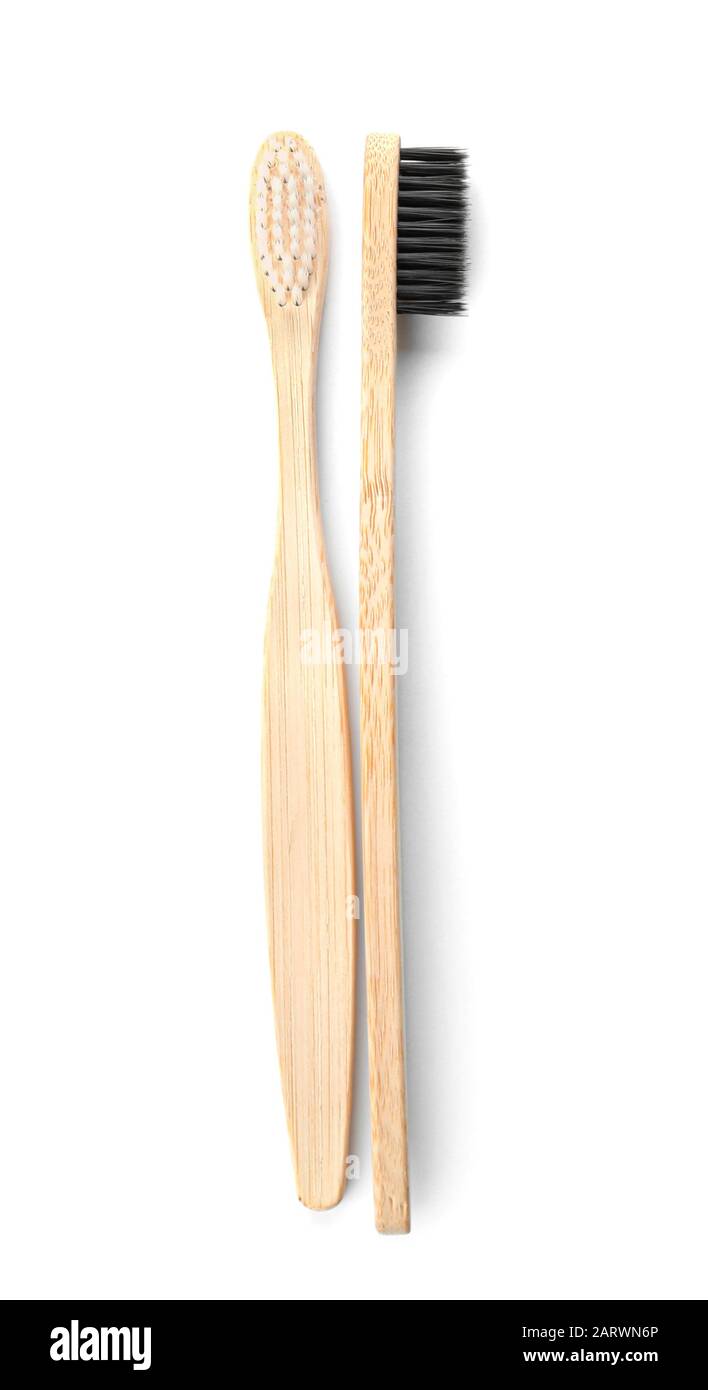 Wooden tooth brushes on white background Stock Photo - Alamy