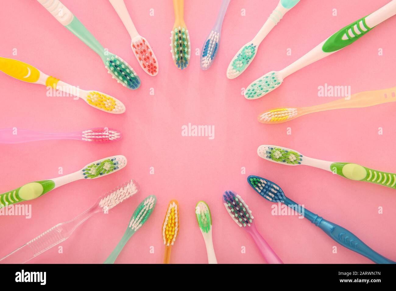 Many different tooth brushes on color background Stock Photo - Alamy