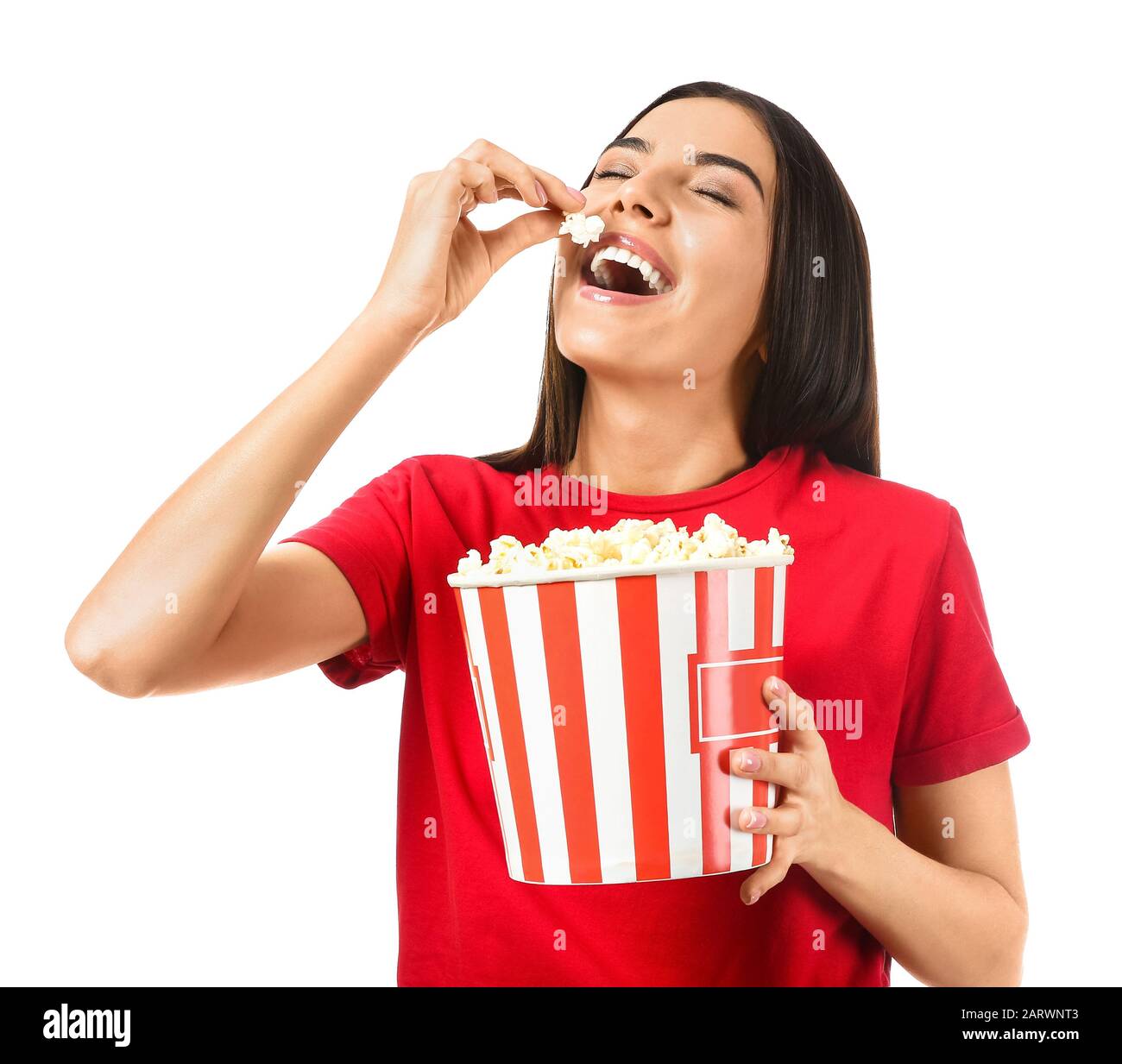 Young woman eating popcorn on white background Stock Photo - Alamy