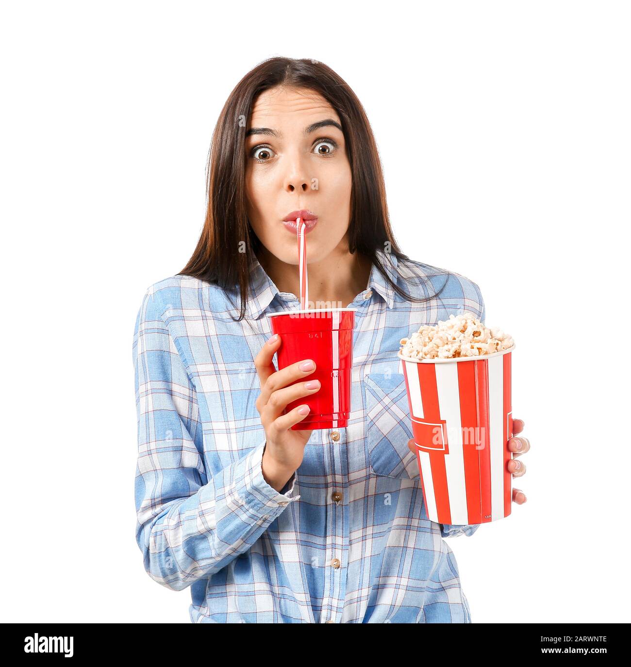 Shocked woman with popcorn drinking soda drink on white background ...