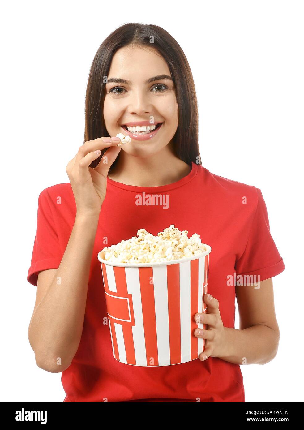 Young woman eating popcorn on white background Stock Photo - Alamy