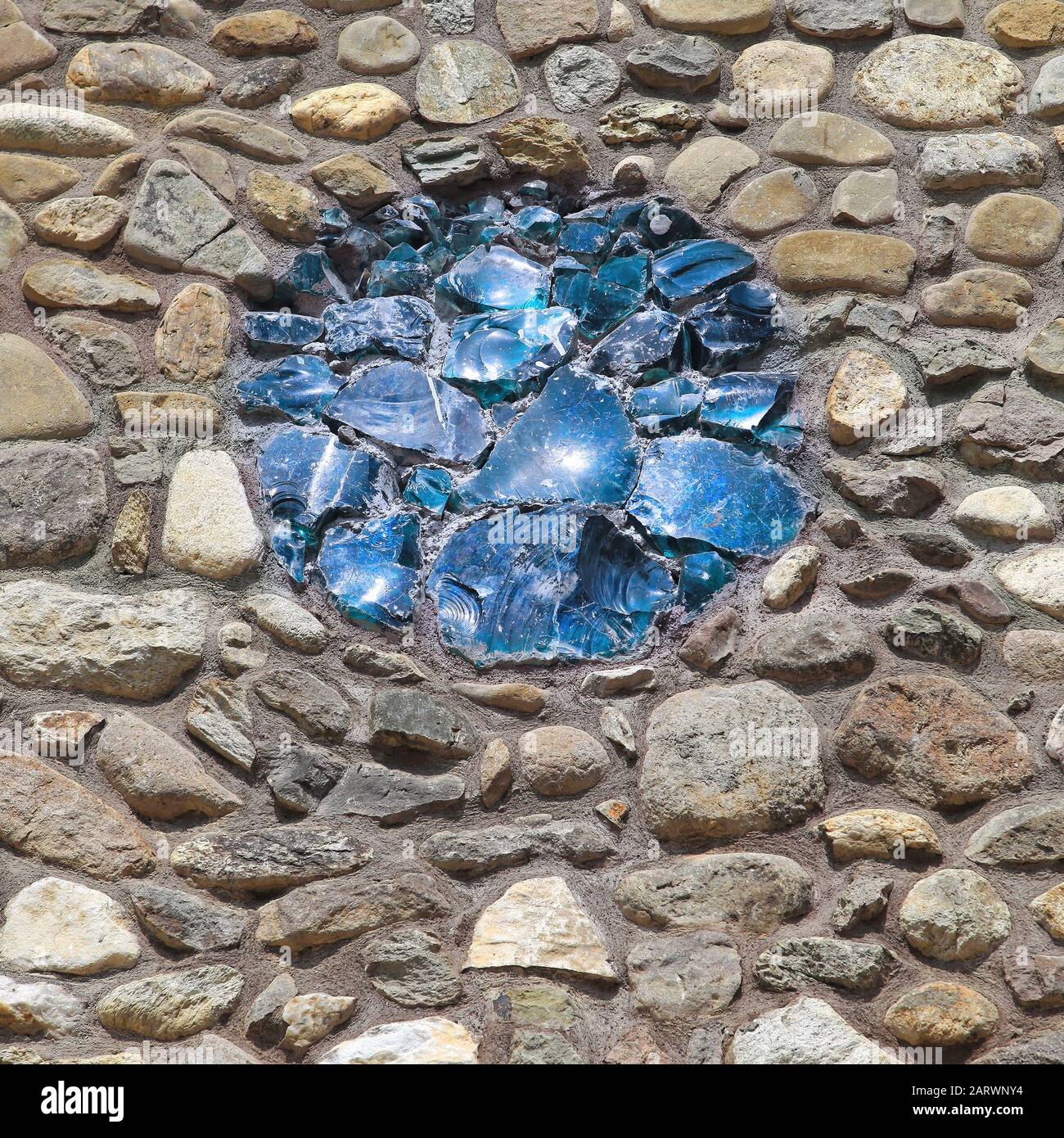 Blue glass decor at stone wall Stock Photo - Alamy