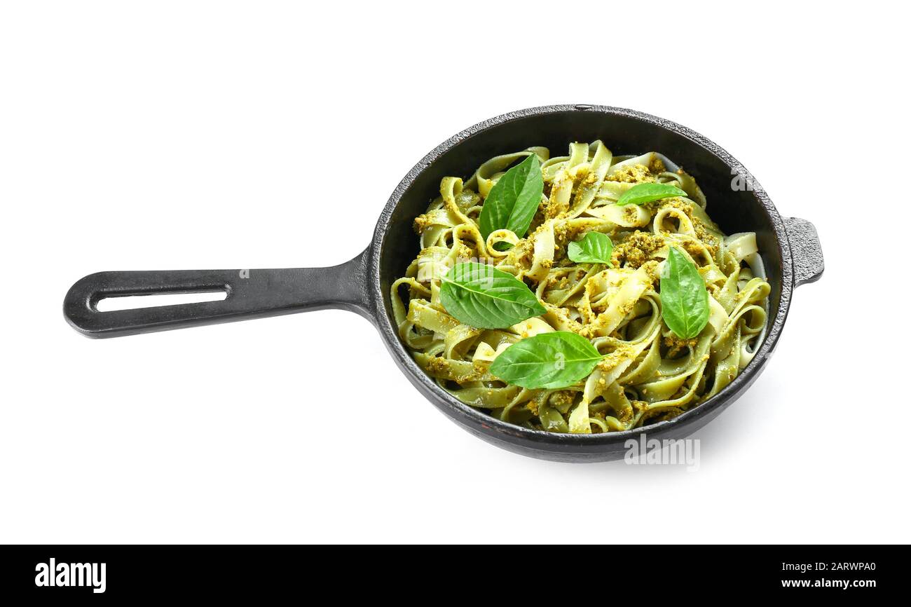 Frying pan with tasty pasta on white background Stock Photo - Alamy