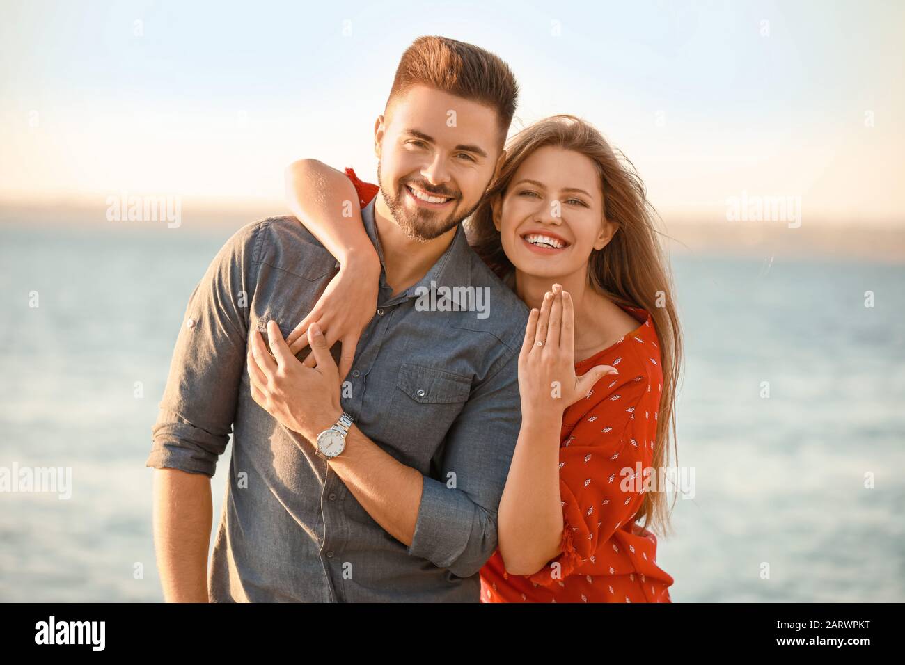 Happy engaged couple near river Stock Photo - Alamy