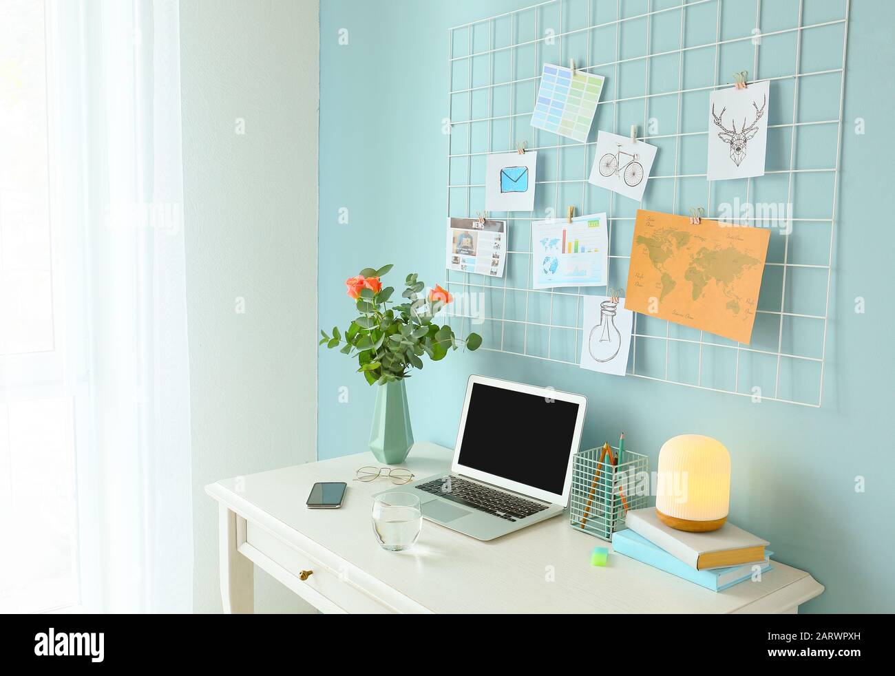 Comfortable workplace with mood board in room Stock Photo - Alamy