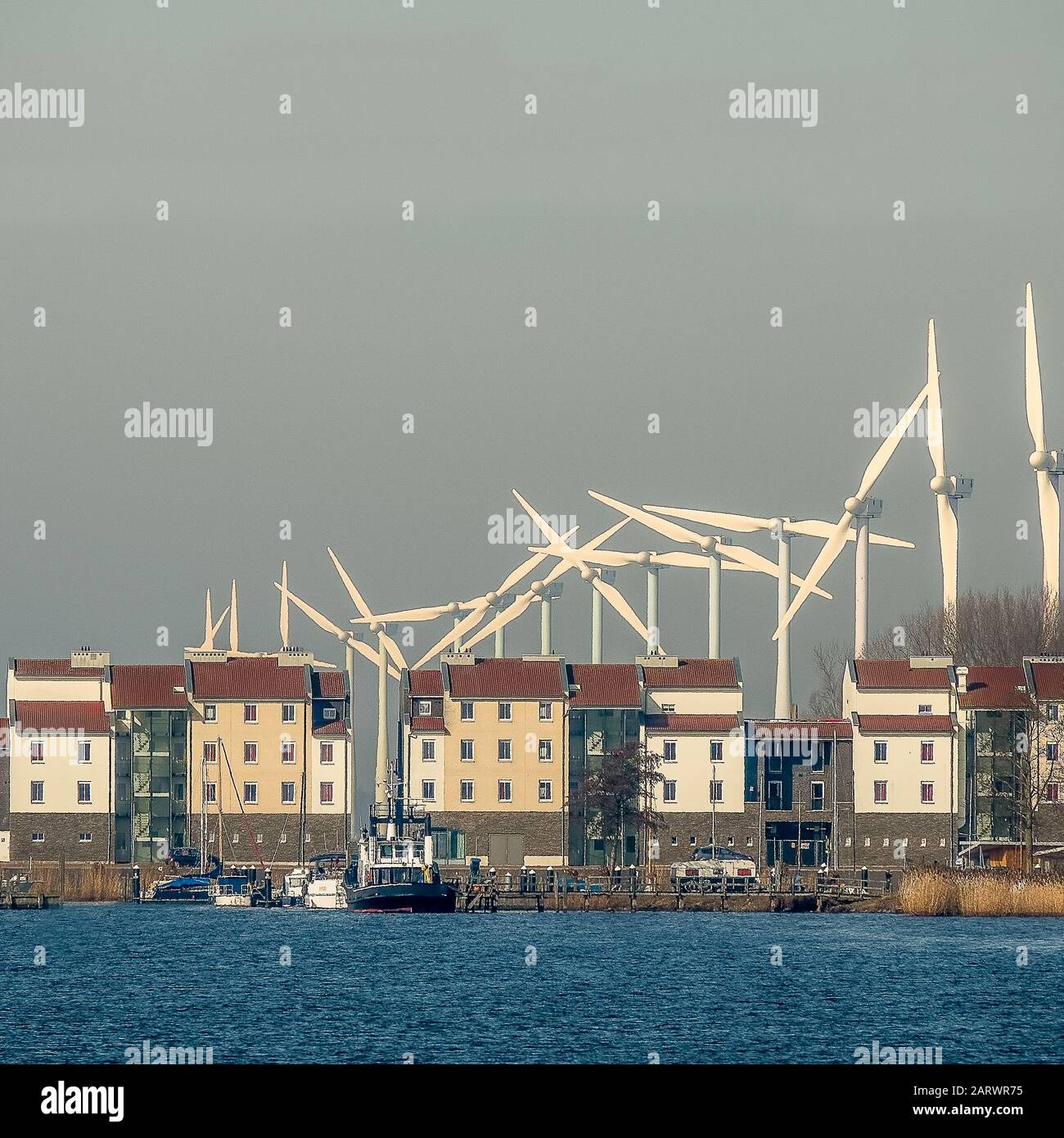 Wide angle shot of white buildings behind wind fans Stock Photo - Alamy