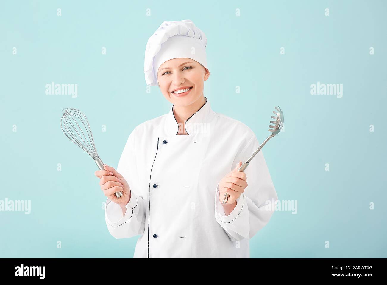 Beautiful female chef with kitchenware on light background Stock Photo ...