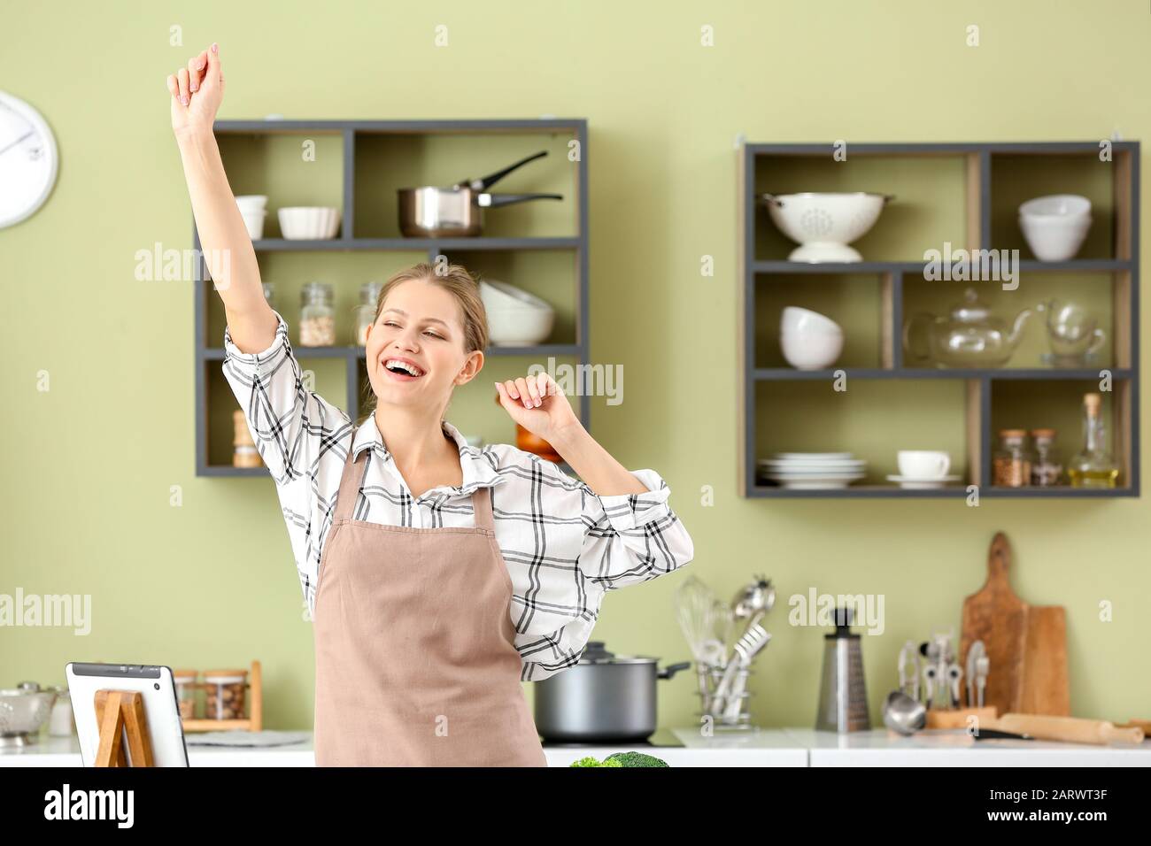 Beautiful young woman dancing in kitchen Stock Photo - Alamy