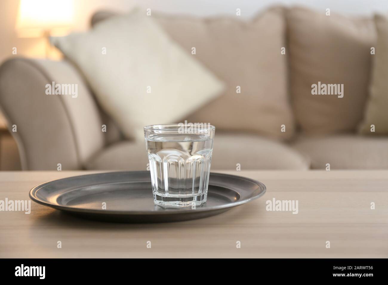 Glass of fresh water on table in room Stock Photo - Alamy