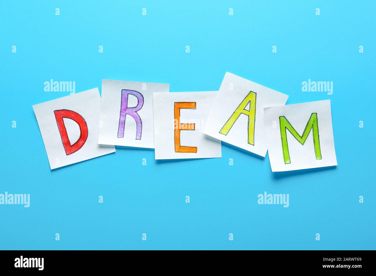 Paper sheets forming word DREAM on color background Stock Photo - Alamy