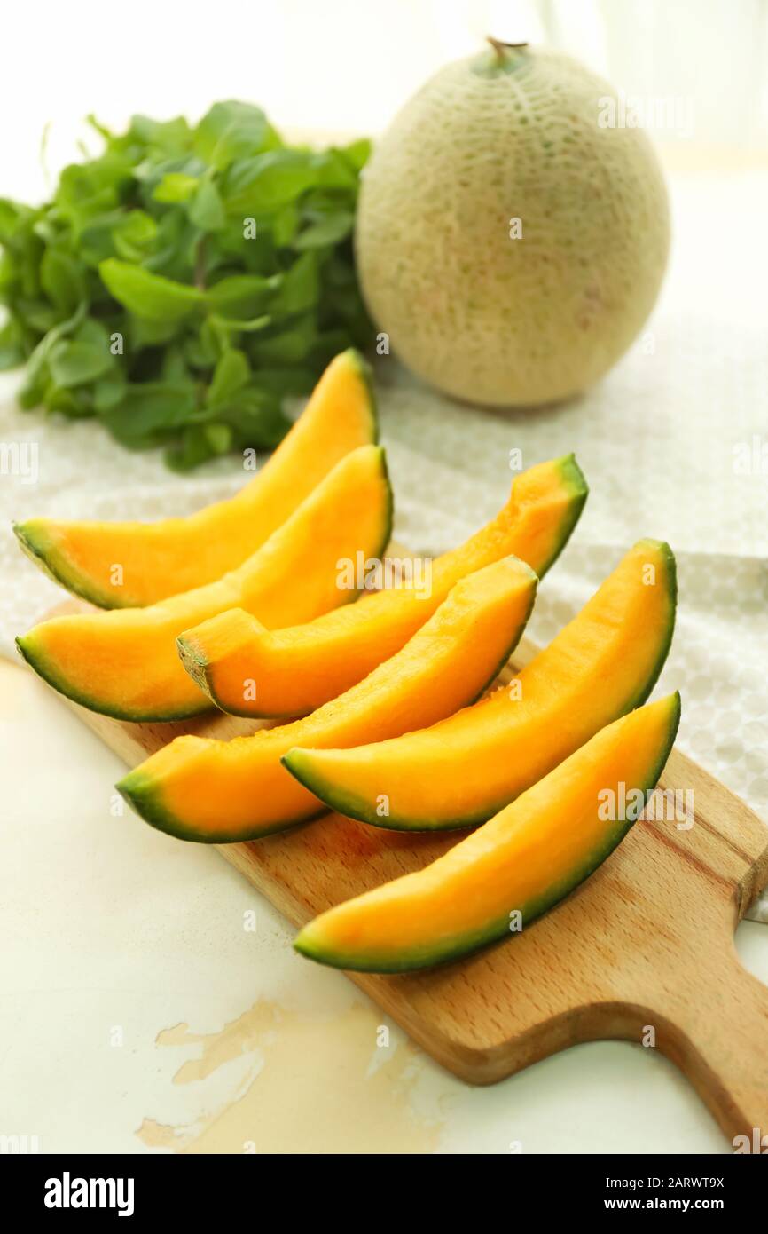 Sweet cut melon on table Stock Photo - Alamy