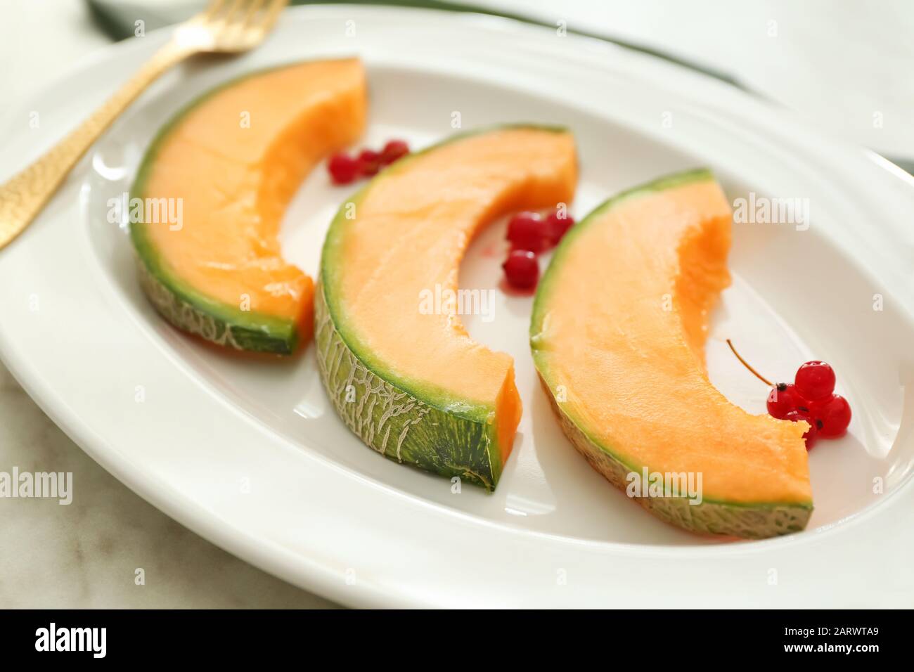 Sweet cut melon on plate, closeup Stock Photo - Alamy