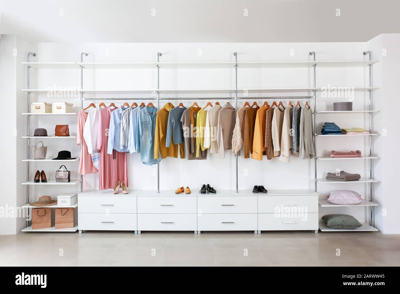 Big wardrobe with clothes in dressing room Stock Photo - Alamy