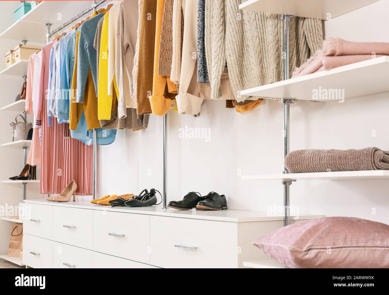 Big wardrobe with clothes in dressing room Stock Photo - Alamy