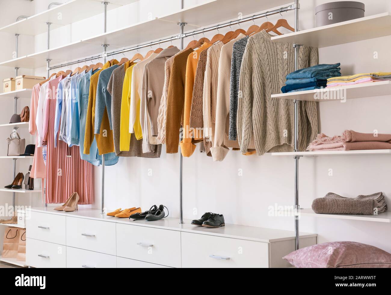 Big wardrobe with clothes in dressing room Stock Photo - Alamy
