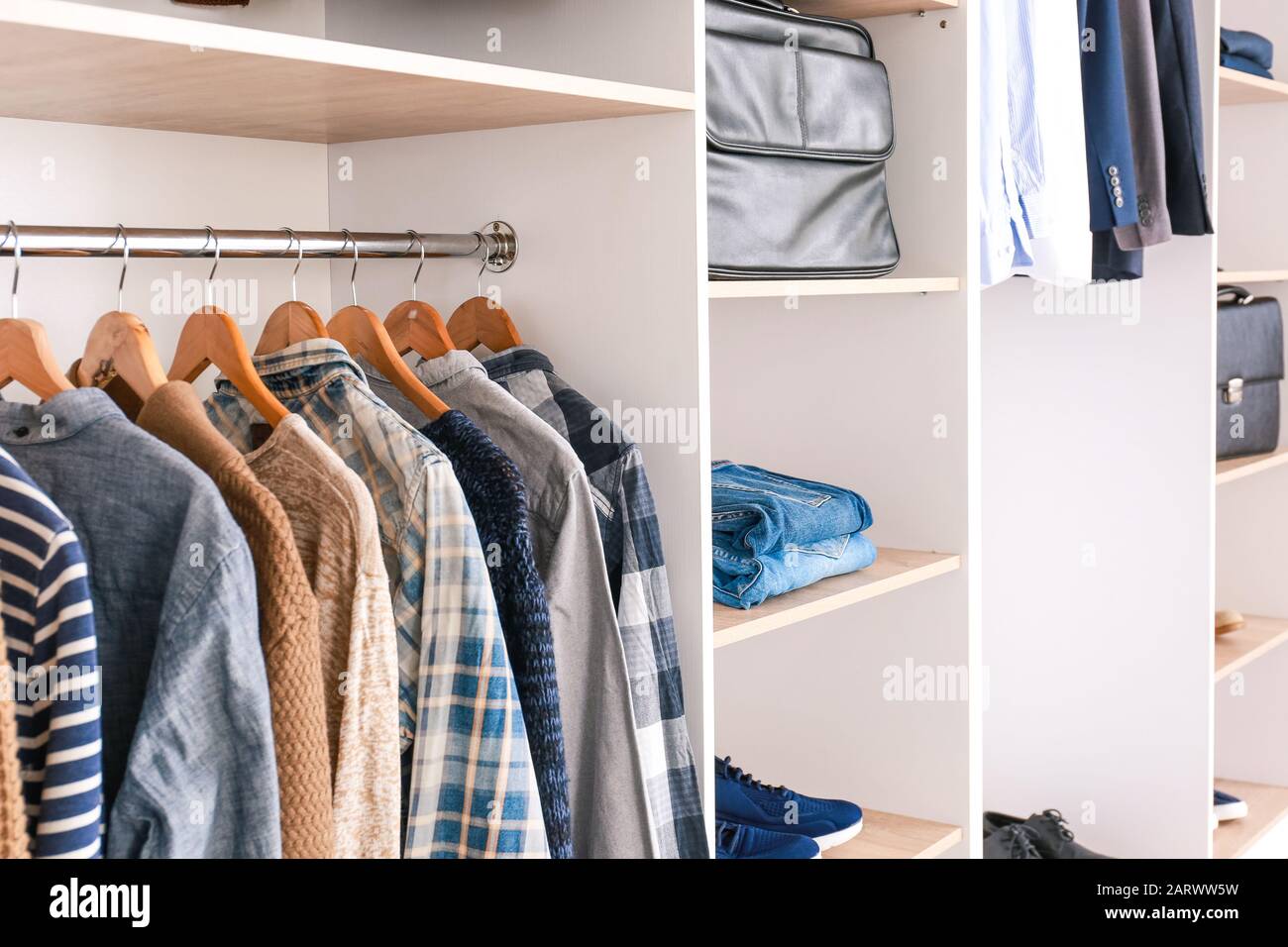 Big wardrobe with clothes in dressing room Stock Photo - Alamy