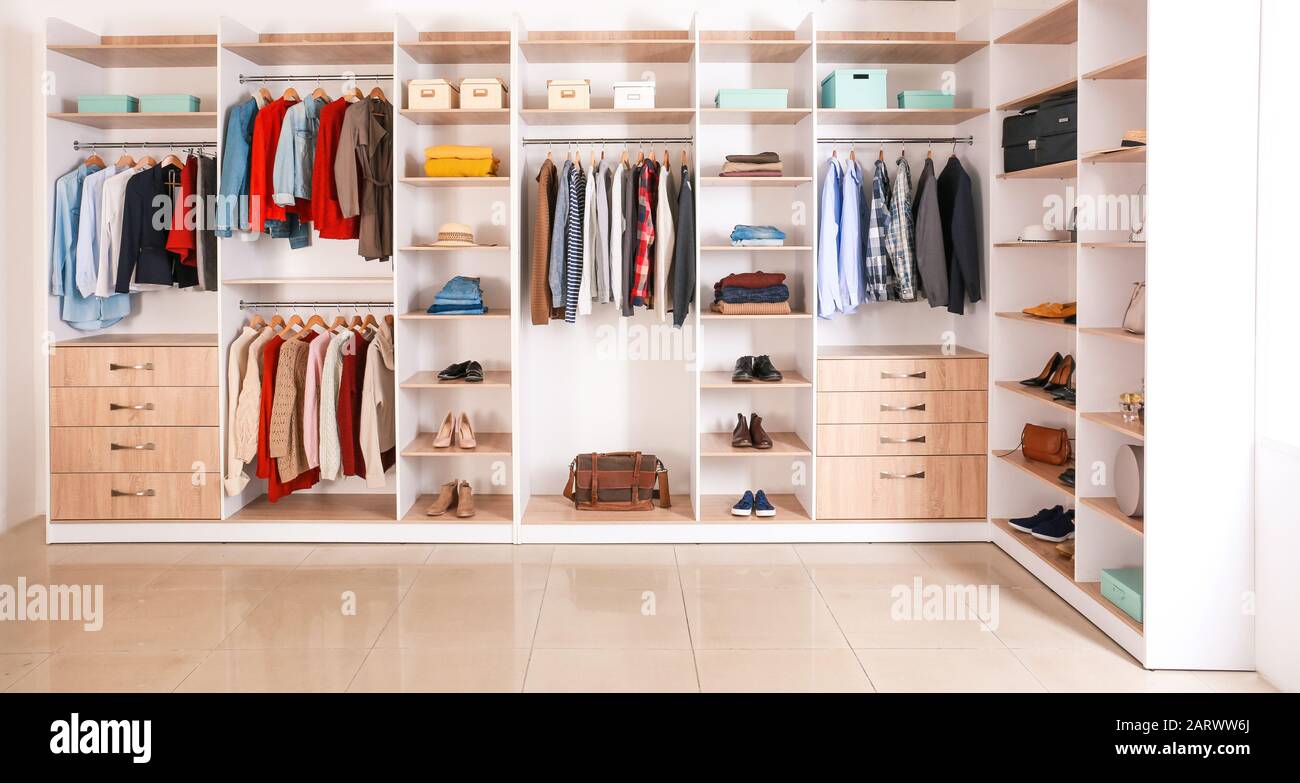 Big wardrobe with clothes in dressing room Stock Photo - Alamy