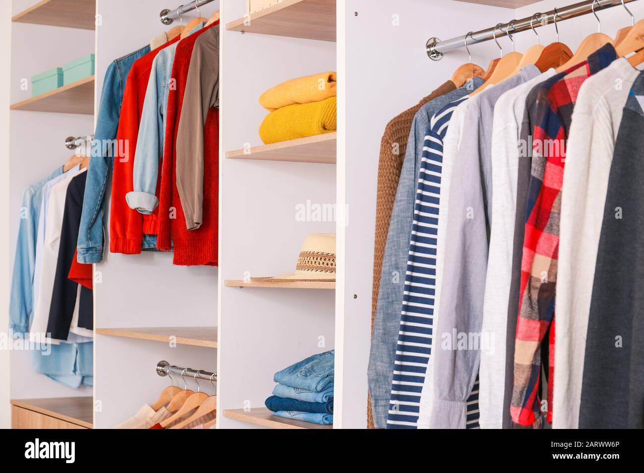 Big wardrobe with clothes in dressing room Stock Photo - Alamy