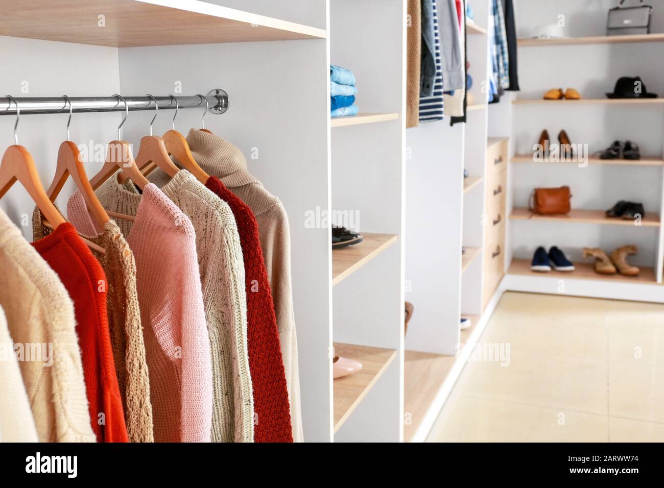 Big wardrobe with clothes in dressing room Stock Photo - Alamy