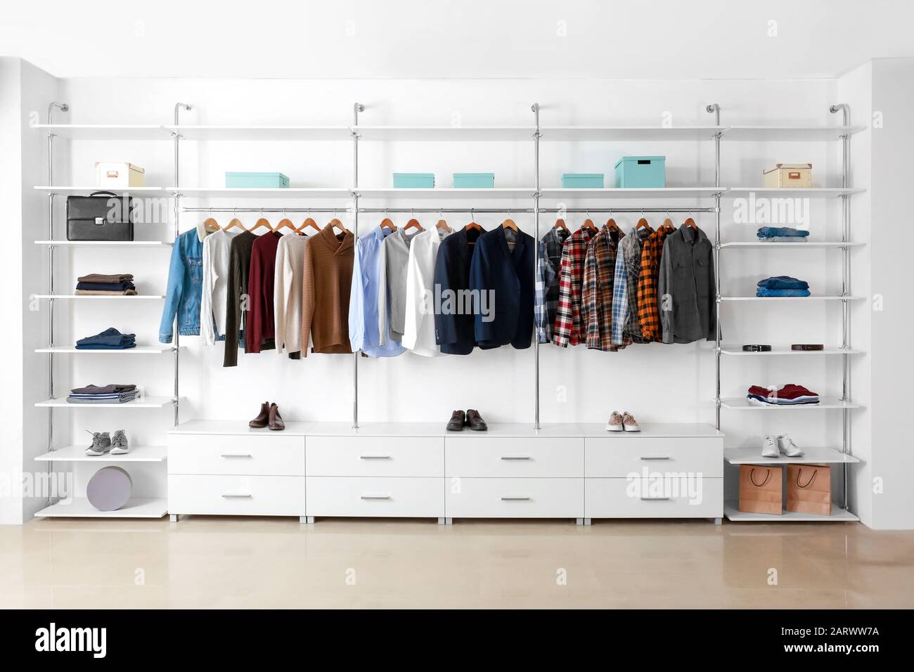 Big wardrobe with clothes in dressing room Stock Photo - Alamy