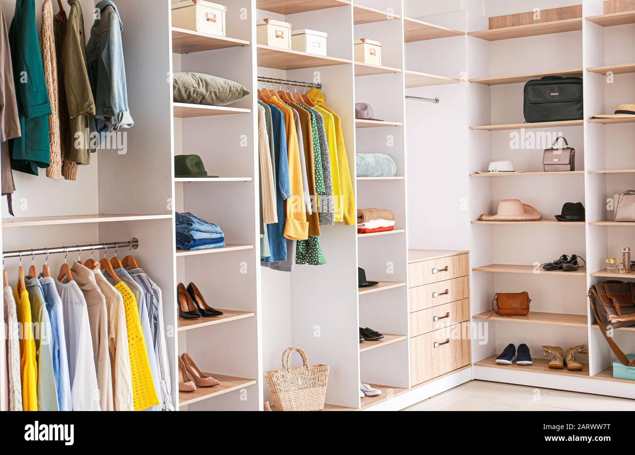 Big wardrobe with clothes in dressing room Stock Photo - Alamy