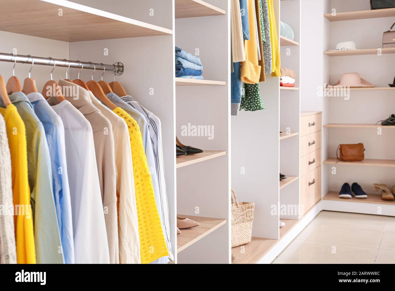 Big wardrobe with clothes in dressing room Stock Photo - Alamy
