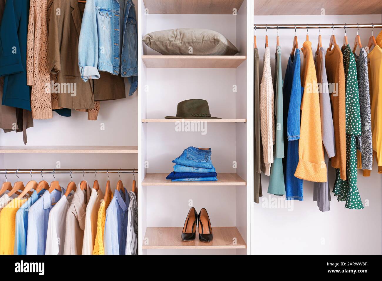 Big wardrobe with clothes in dressing room Stock Photo - Alamy
