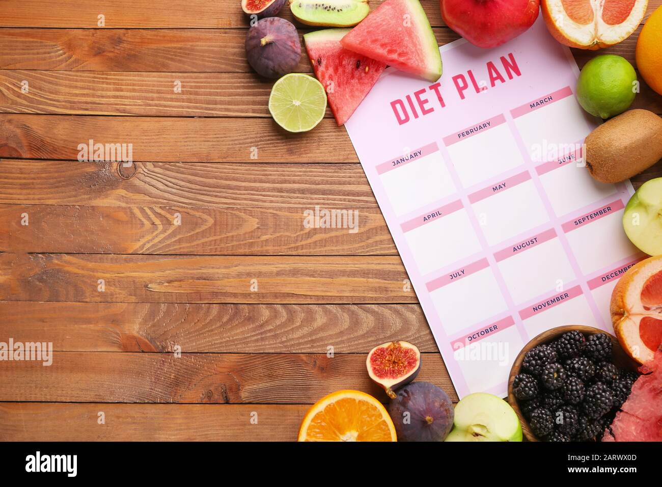 Different healthy food with diet plan on wooden table Stock Photo - Alamy