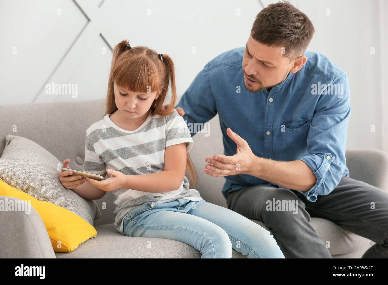 Little girl with mobile phone ignoring her angry father at home Stock ... Little girl with mobile phone ignoring her angry father at home Stock ...