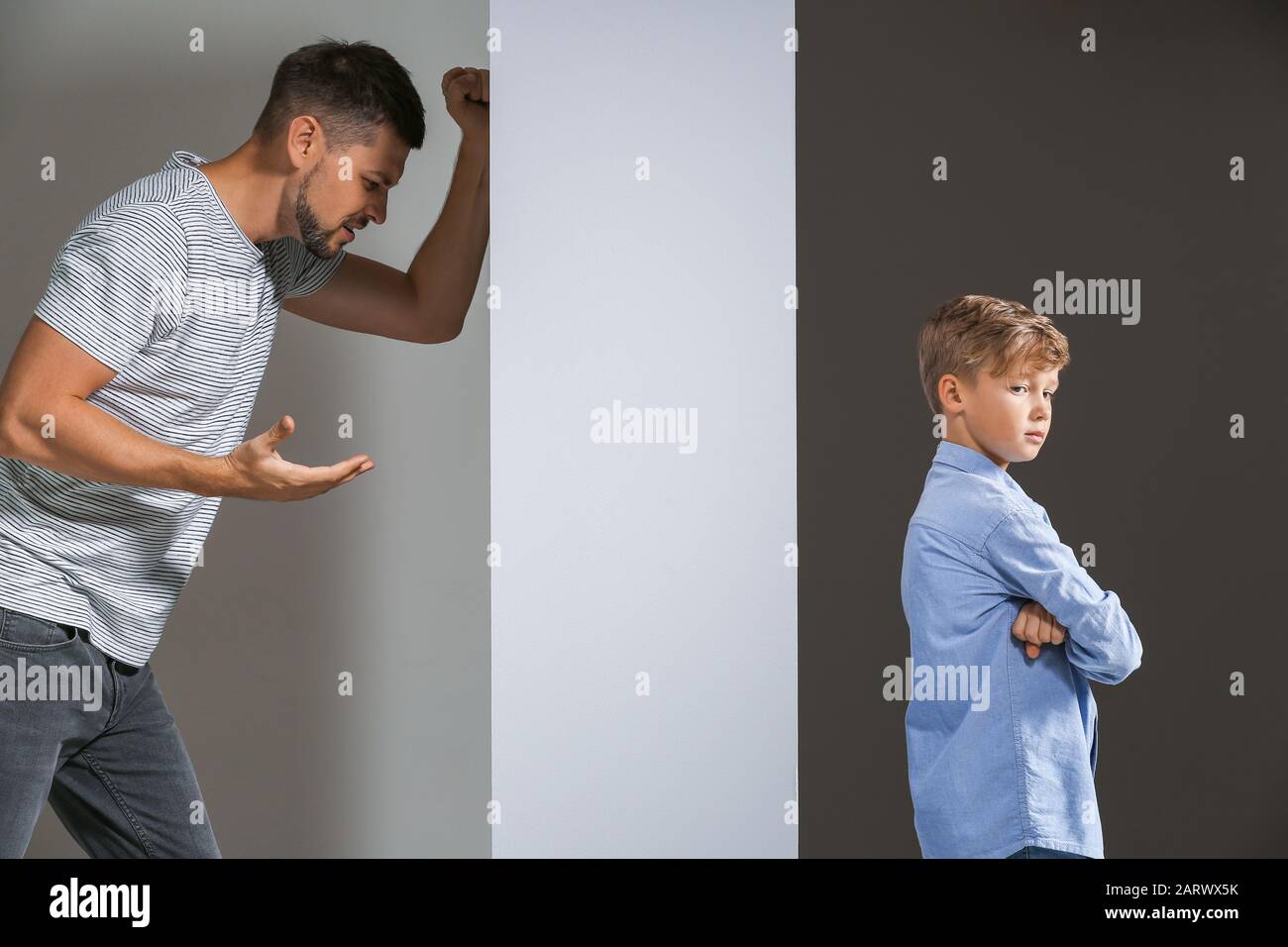 Father talking to his little son through the wall. Concept of ...