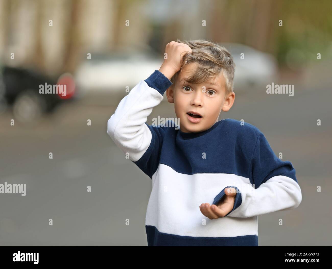 Stressed little boy walking outdoors Stock Photo - Alamy