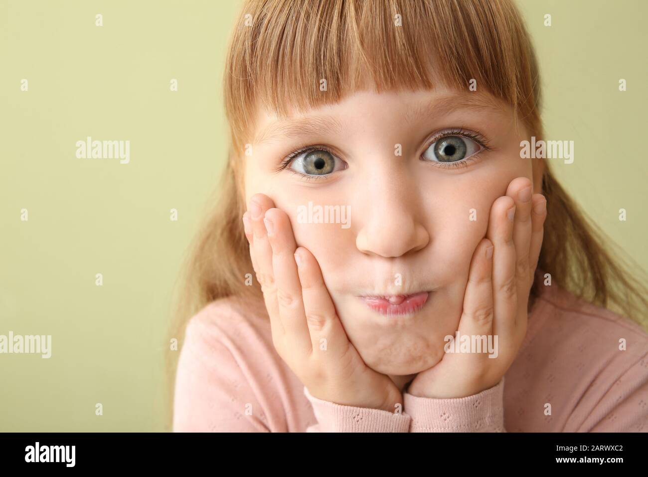 Grimacing little girl on color background, closeup Stock Photo - Alamy