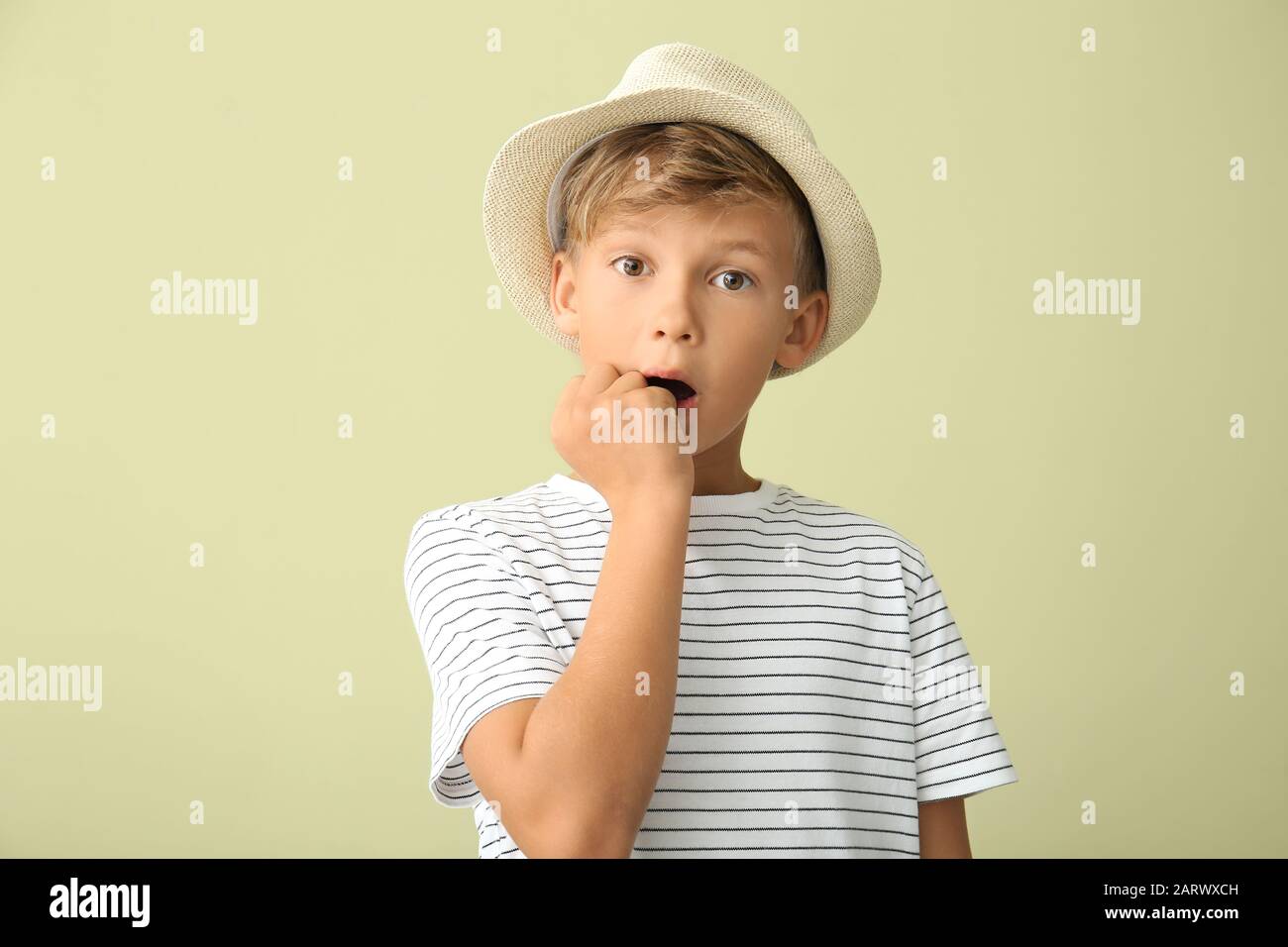 Surprised little boy on color background Stock Photo - Alamy