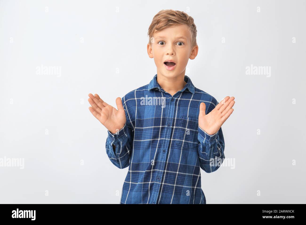 Surprised little boy on white background Stock Photo - Alamy