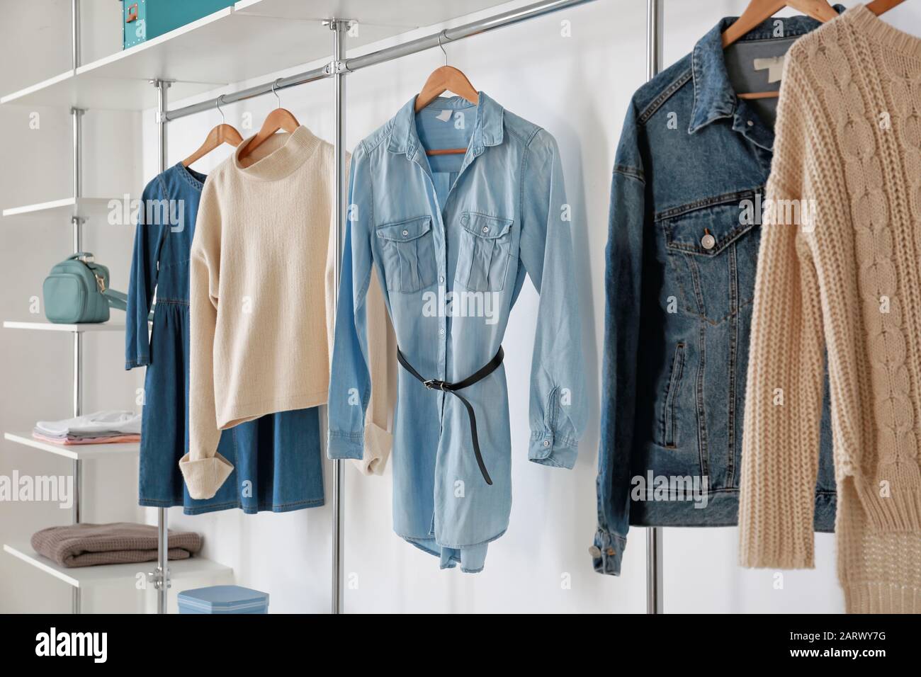 Big wardrobe with different clothes and accessories in dressing room ...