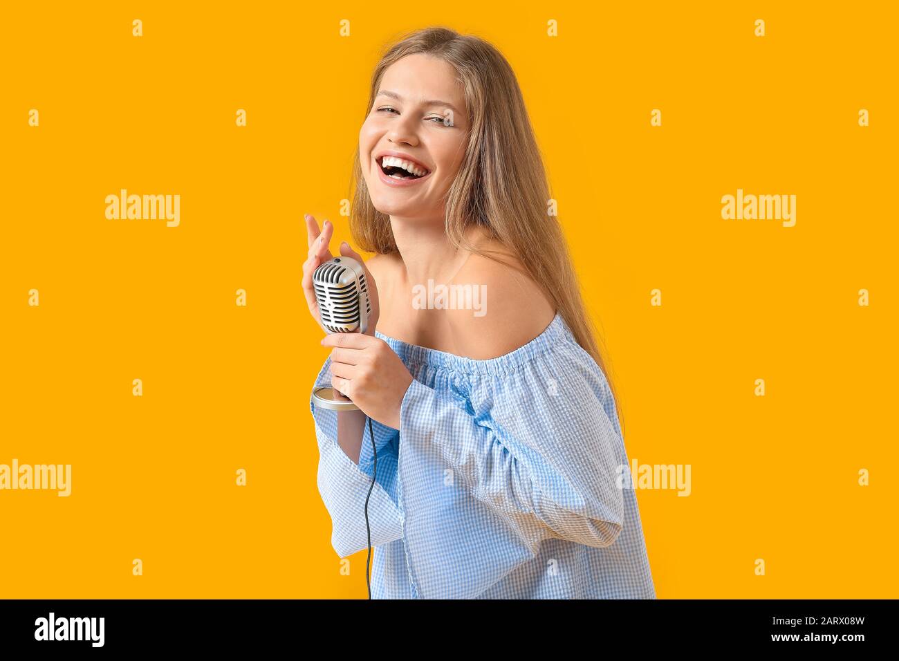 Beautiful young female singer with microphone on color background Stock ...