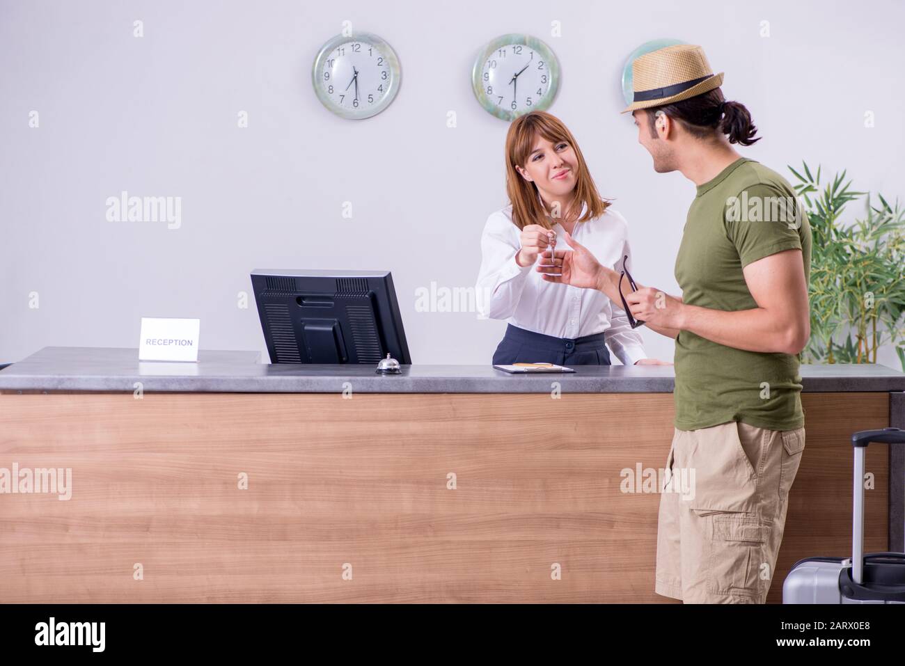 Hotel receptionist giving out key hi-res stock photography and images ...
