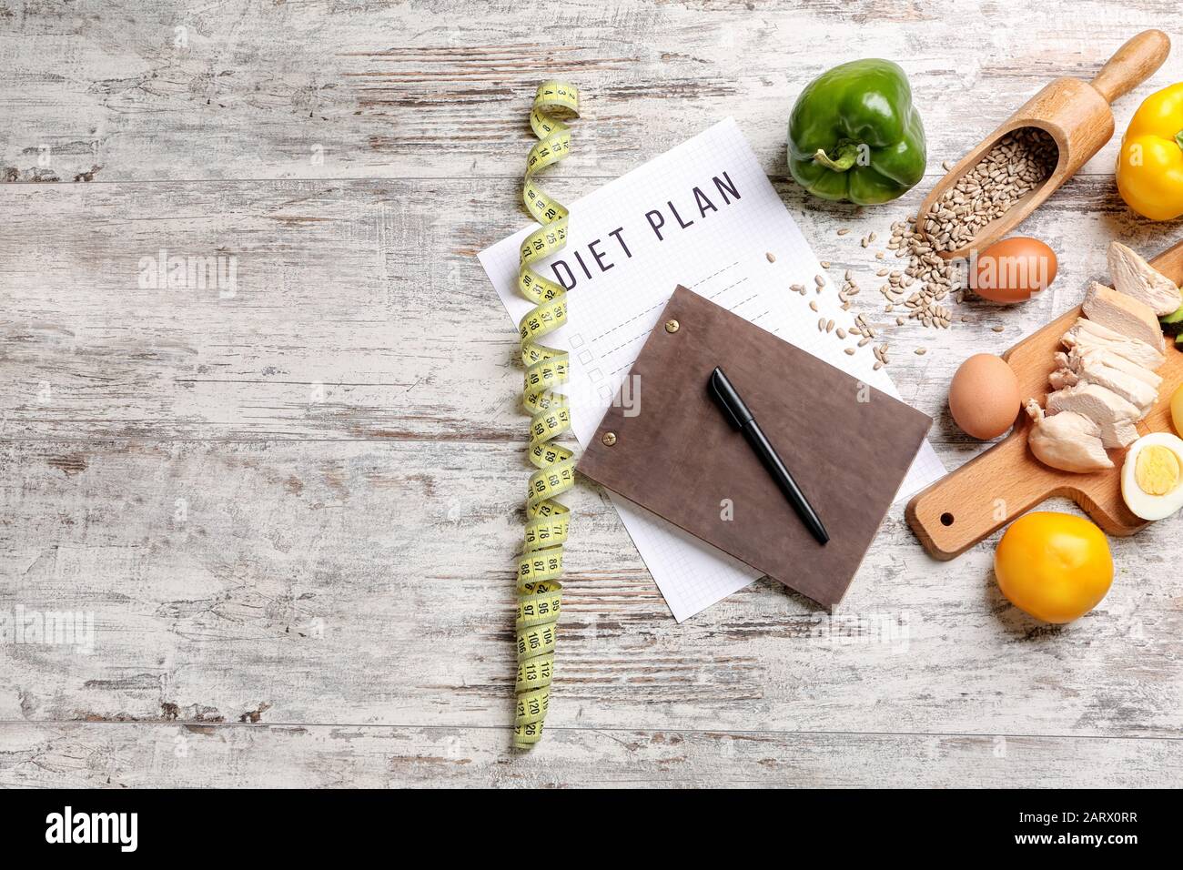 Sheet of paper with diet plan, measuring tape and healthy products on ...