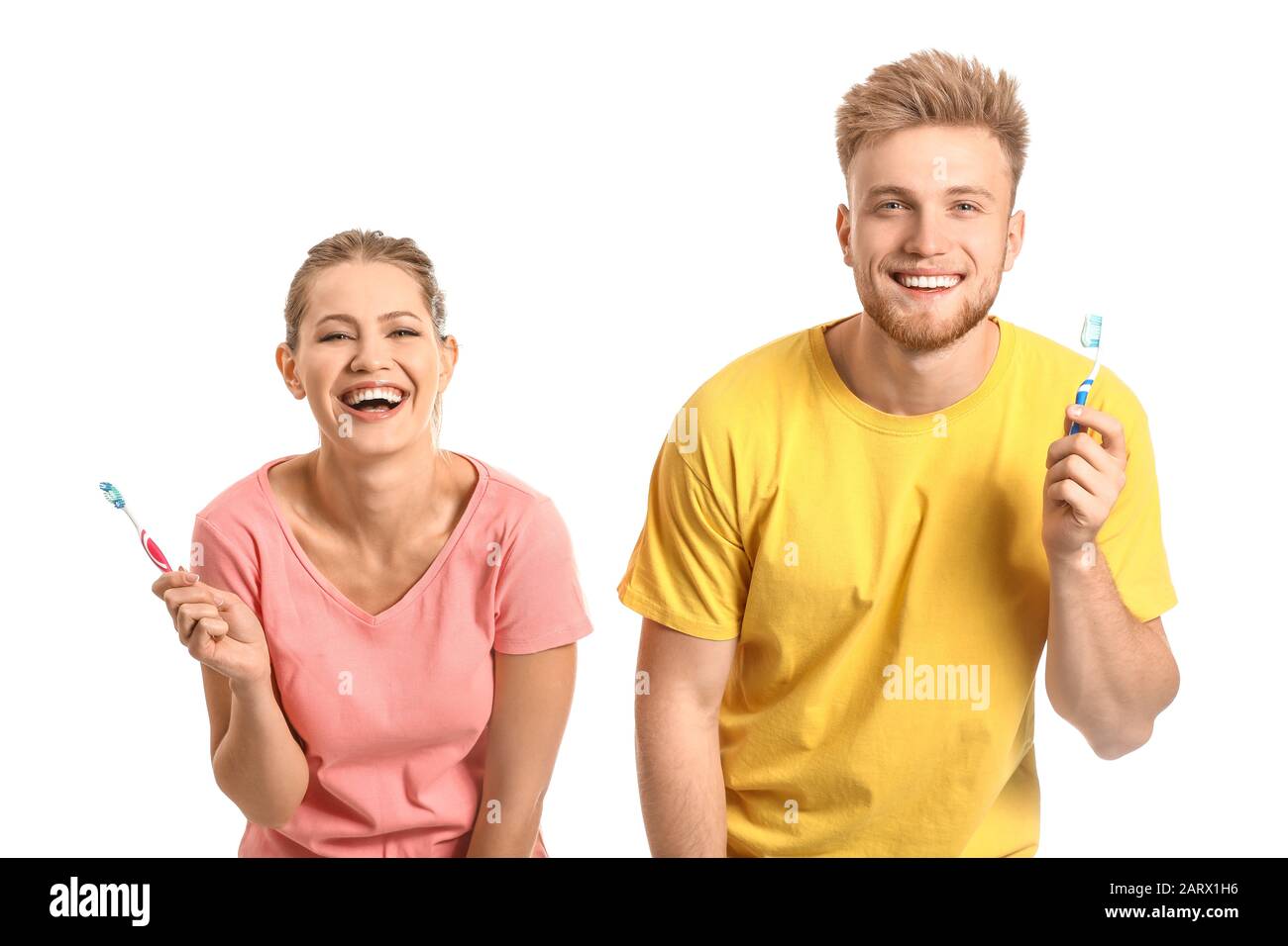 Young couple with toothbrushes on white background Stock Photo - Alamy