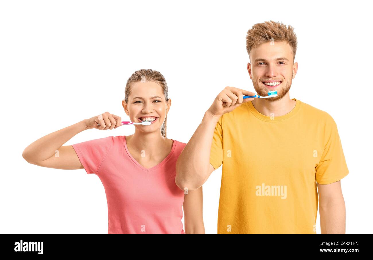 Young couple brushing teeth on white background Stock Photo - Alamy