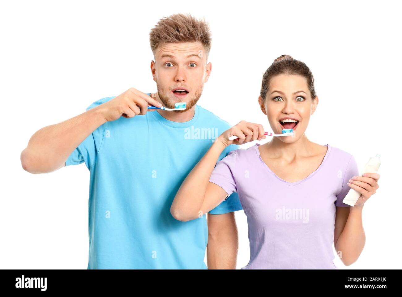 Young couple brushing teeth on white background Stock Photo - Alamy