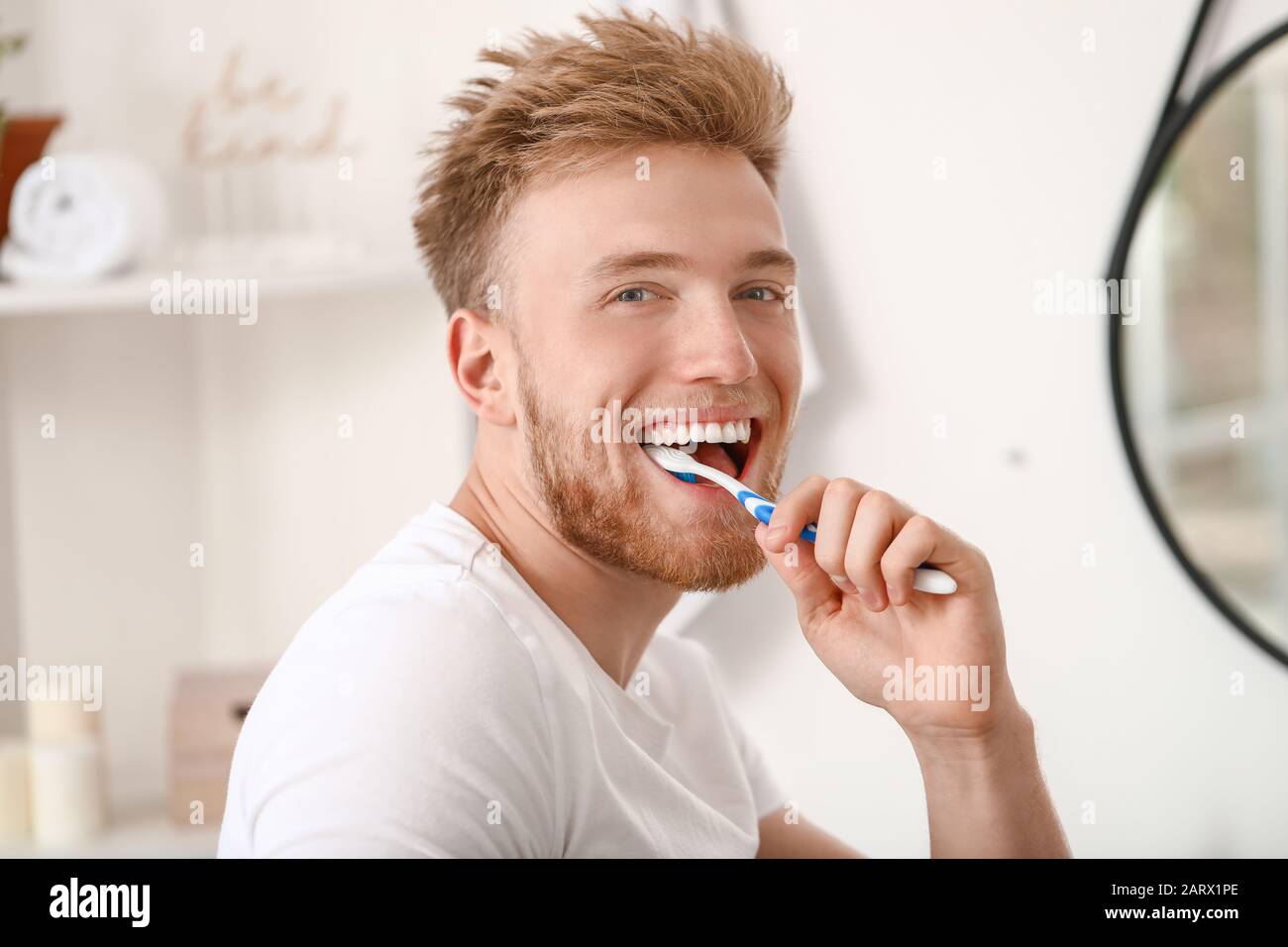 Young man brushing teeth at home Stock Photo - Alamy