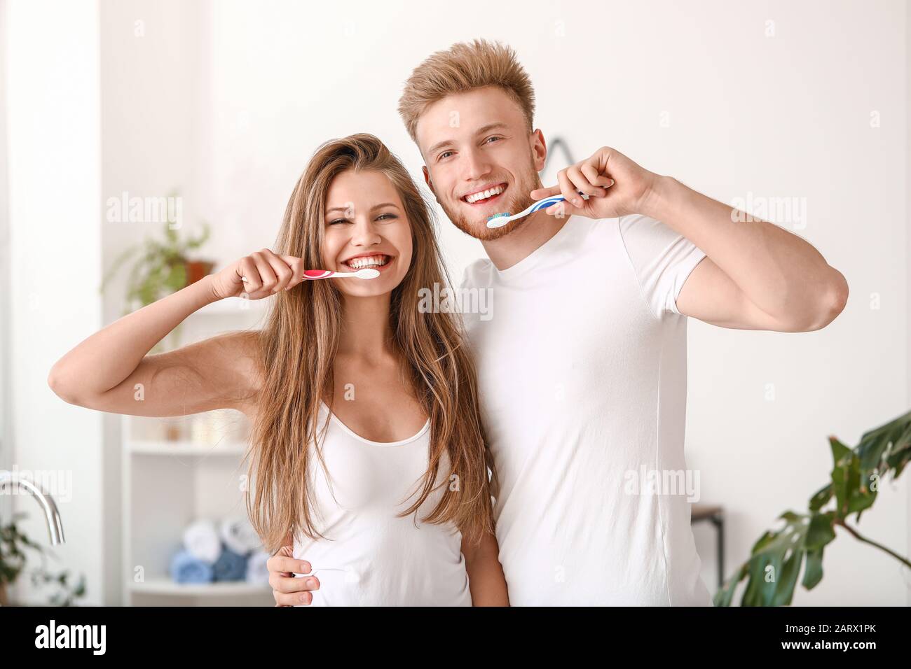 Young couple brushing teeth at home Stock Photo - Alamy