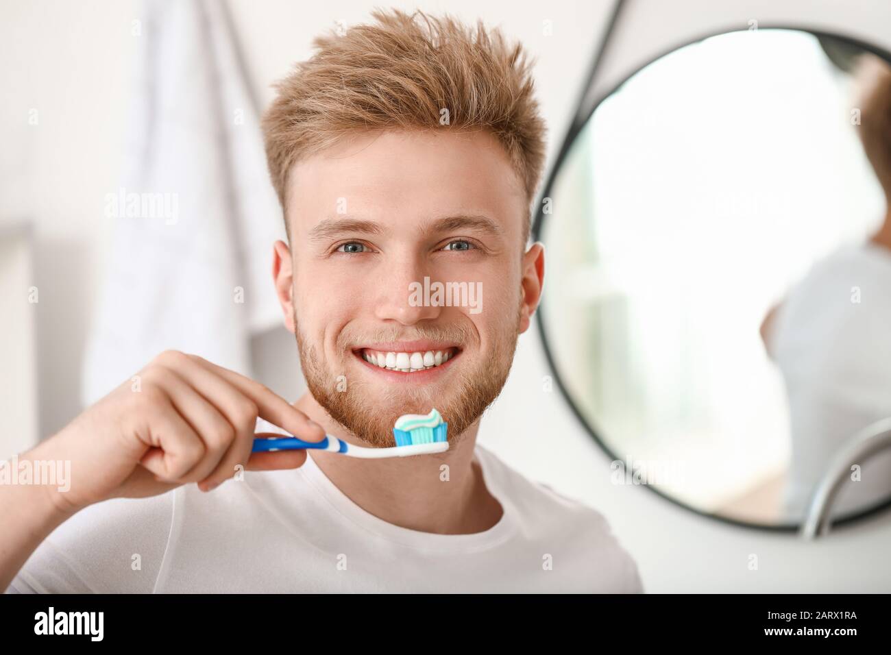 Young man brushing teeth at home Stock Photo - Alamy