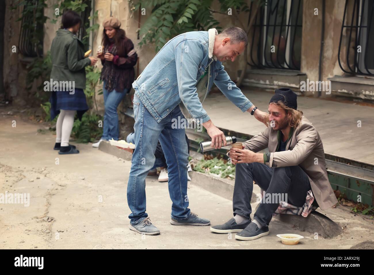 Helping homeless drink hi-res stock photography and images - Alamy