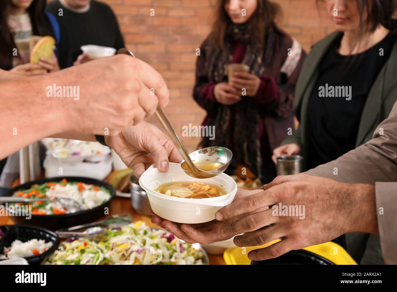 Volunteers giving food to homeless people Stock Photo - Alamy