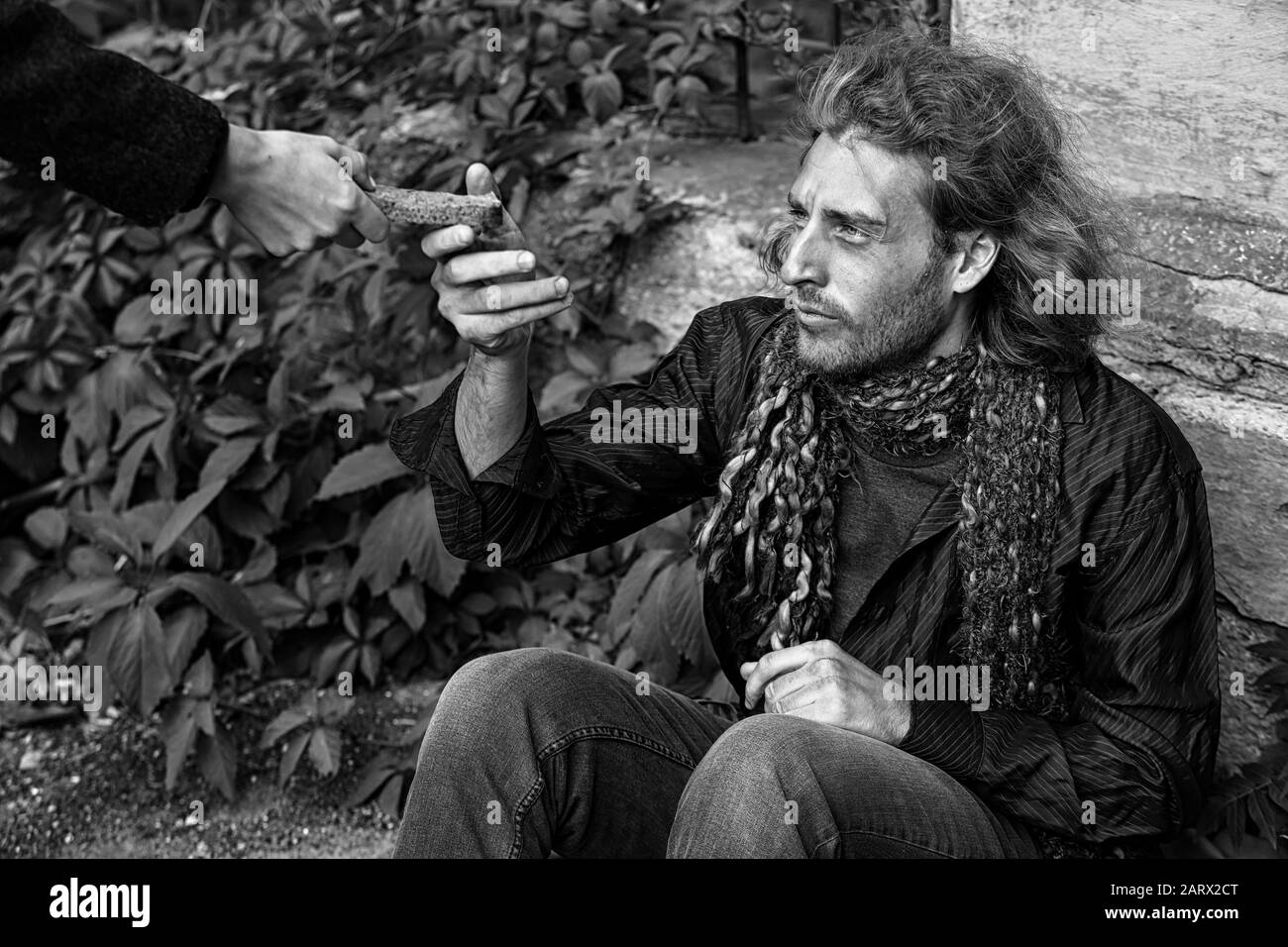 Woman giving bread to poor homeless man outdoors Stock Photo - Alamy